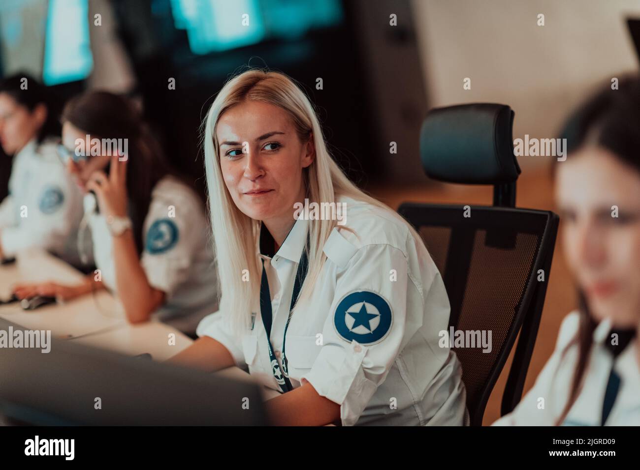 Female security operator working in a data system control room offices ...