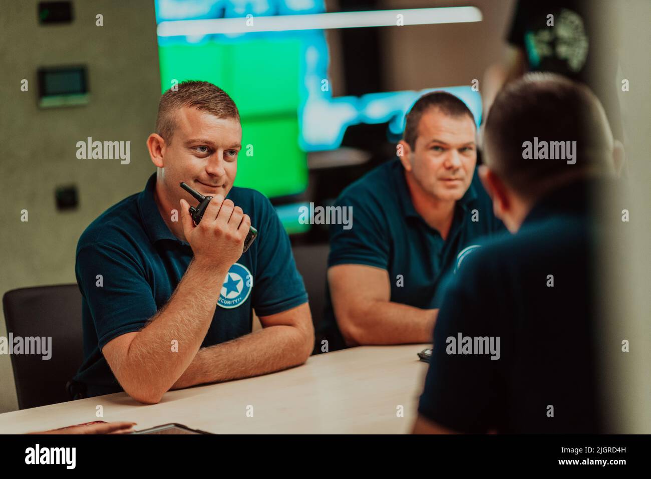 Group of security guards sitting and having briefing In the system ...