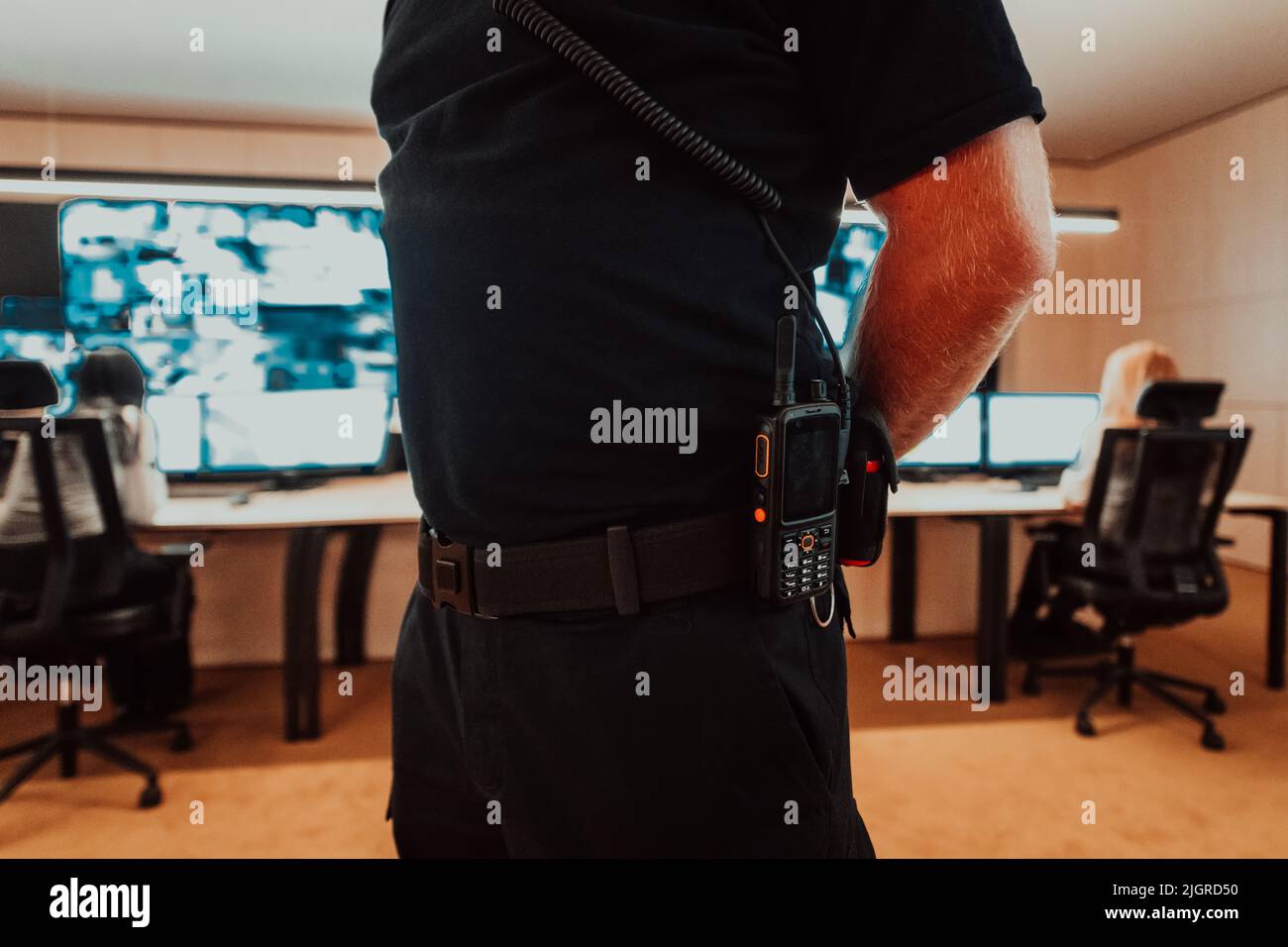 Male security operator working in a data system control room offices ...