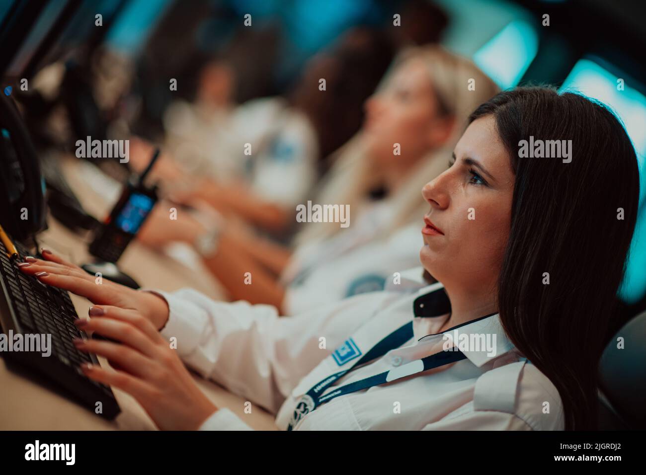 Female security operator working in a data system control room offices ...