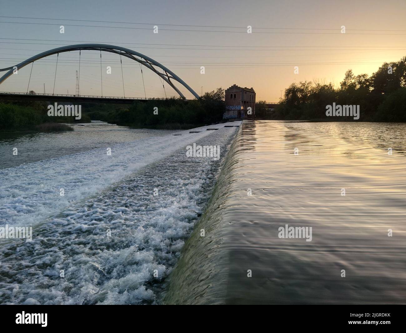 A breathtaking view from the river of Abbas ibn Firnas Bridge in Spain ...