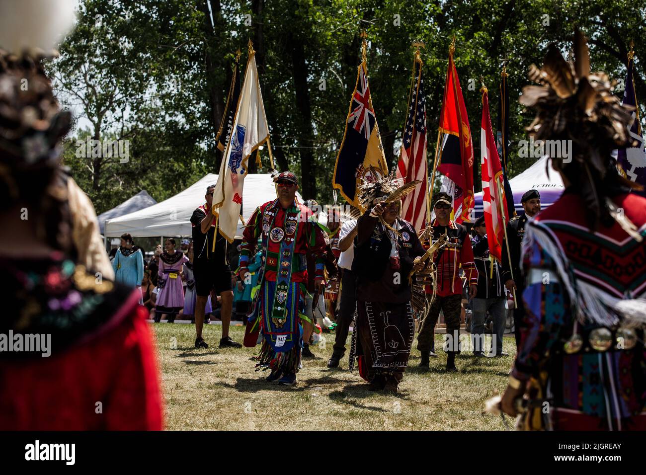Kahnawake, Canada. 10th July, 2022. Participants hold flags at the ...
