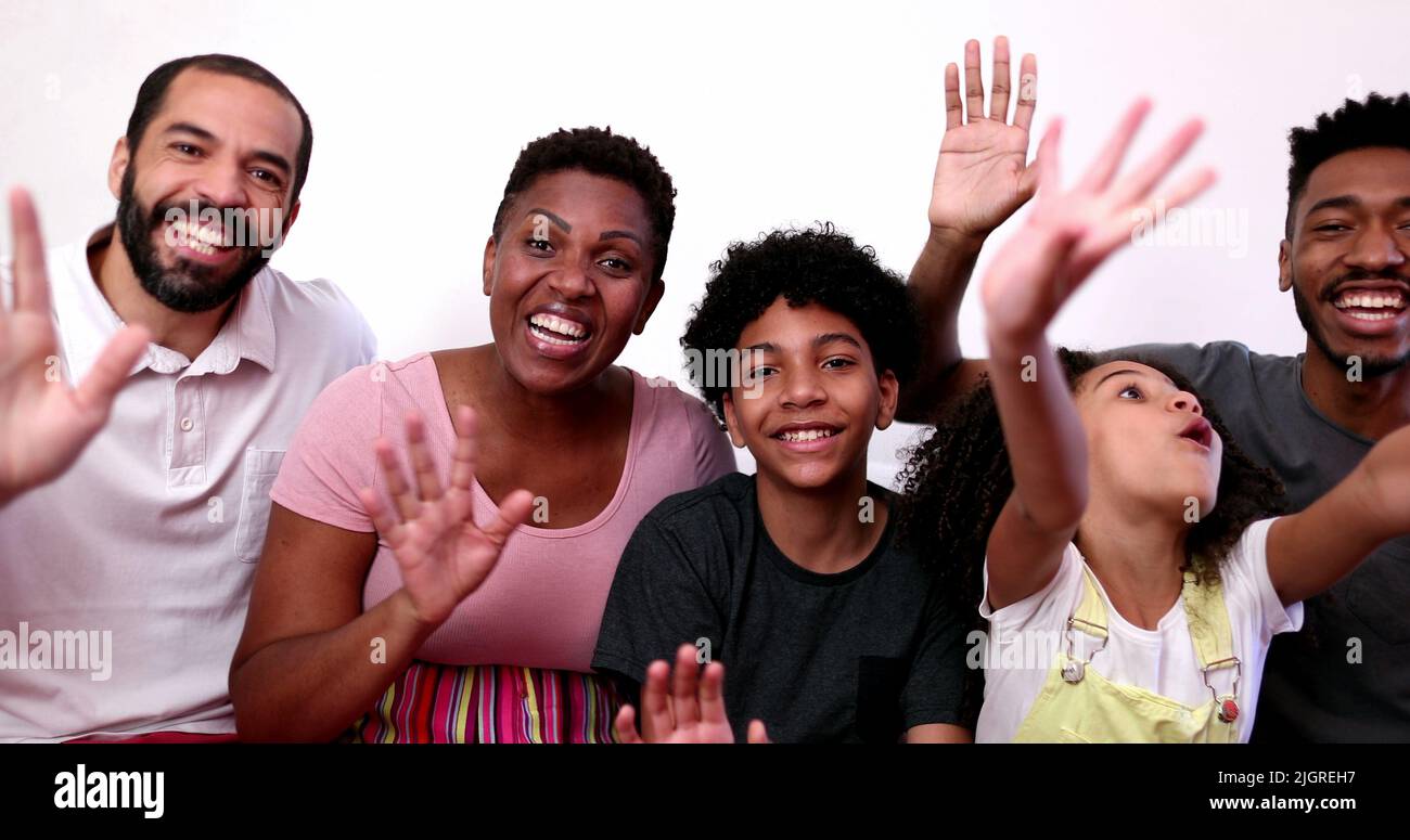 Black African family waving hello to camera, parent and kids talking to ...
