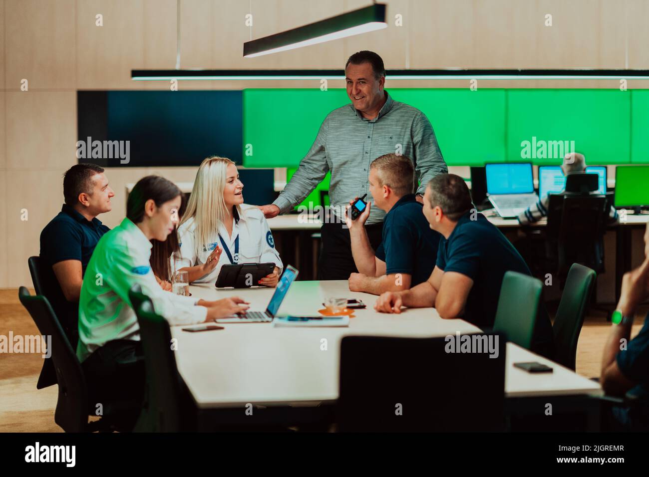 Group of security guards sitting and having briefing In the system ...