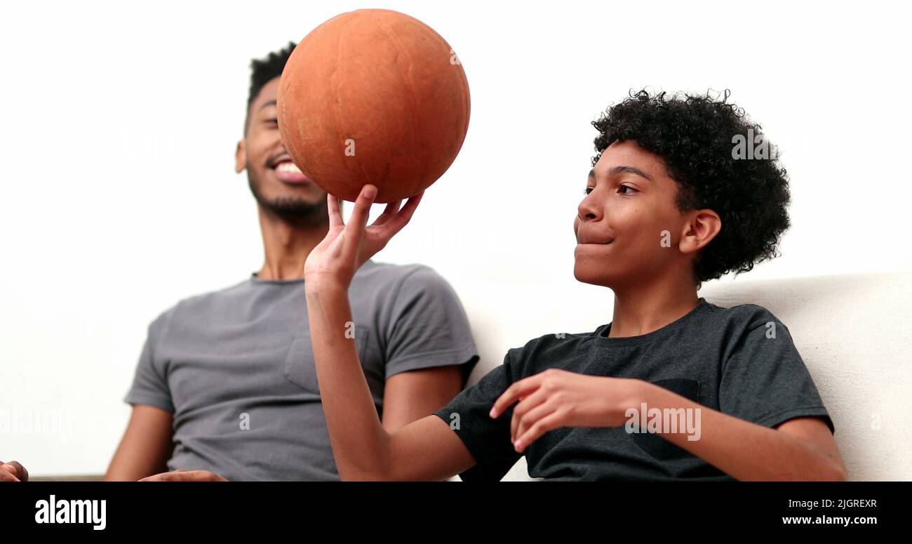 Brothers bonding together with basketball. Mixed race, black ethnicity ...