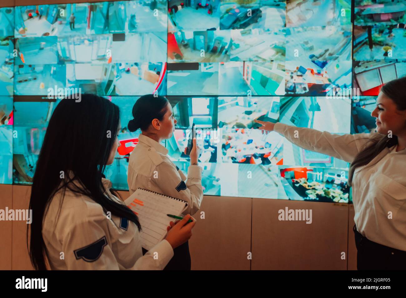 Group of female security operators working in a data system control ...