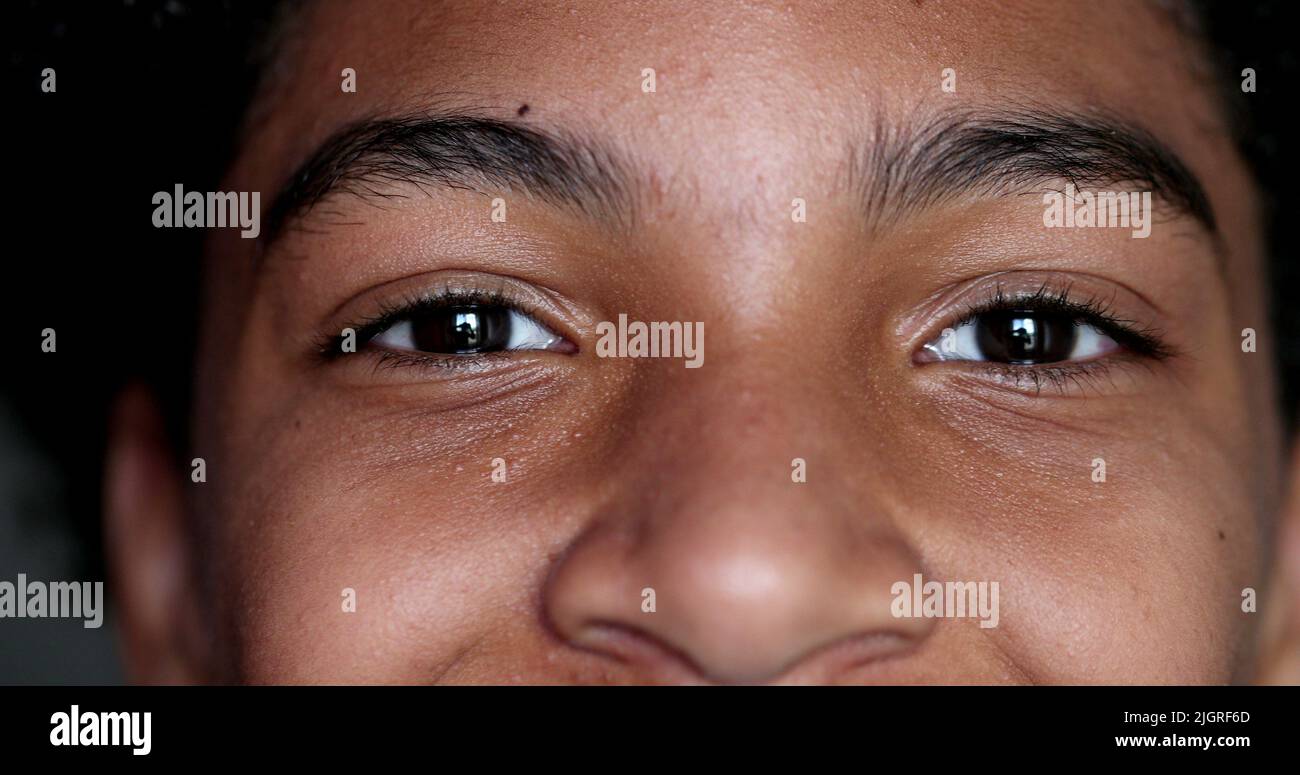 Child closing eyes taking a deep breath and smiling at camera. Macro ...