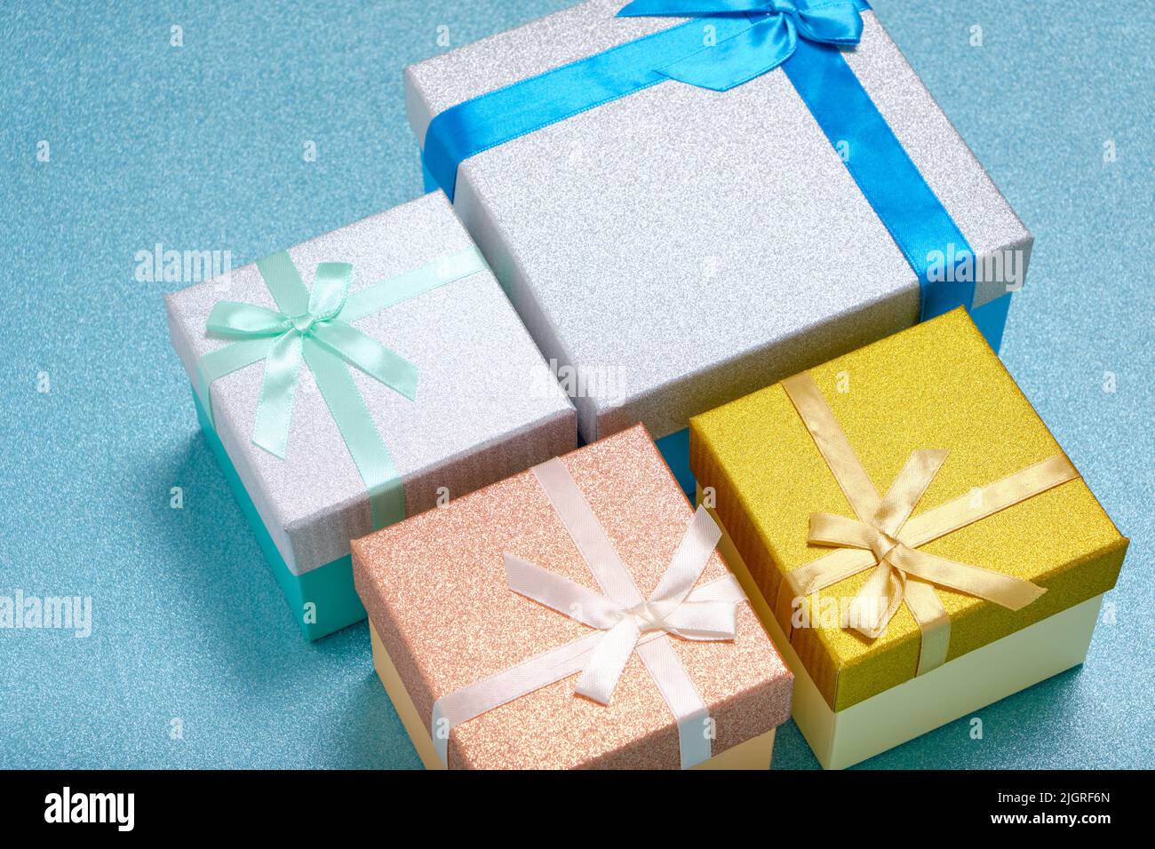 Holiday gifts in gift boxes blue shiny background Stock Photo - Alamy