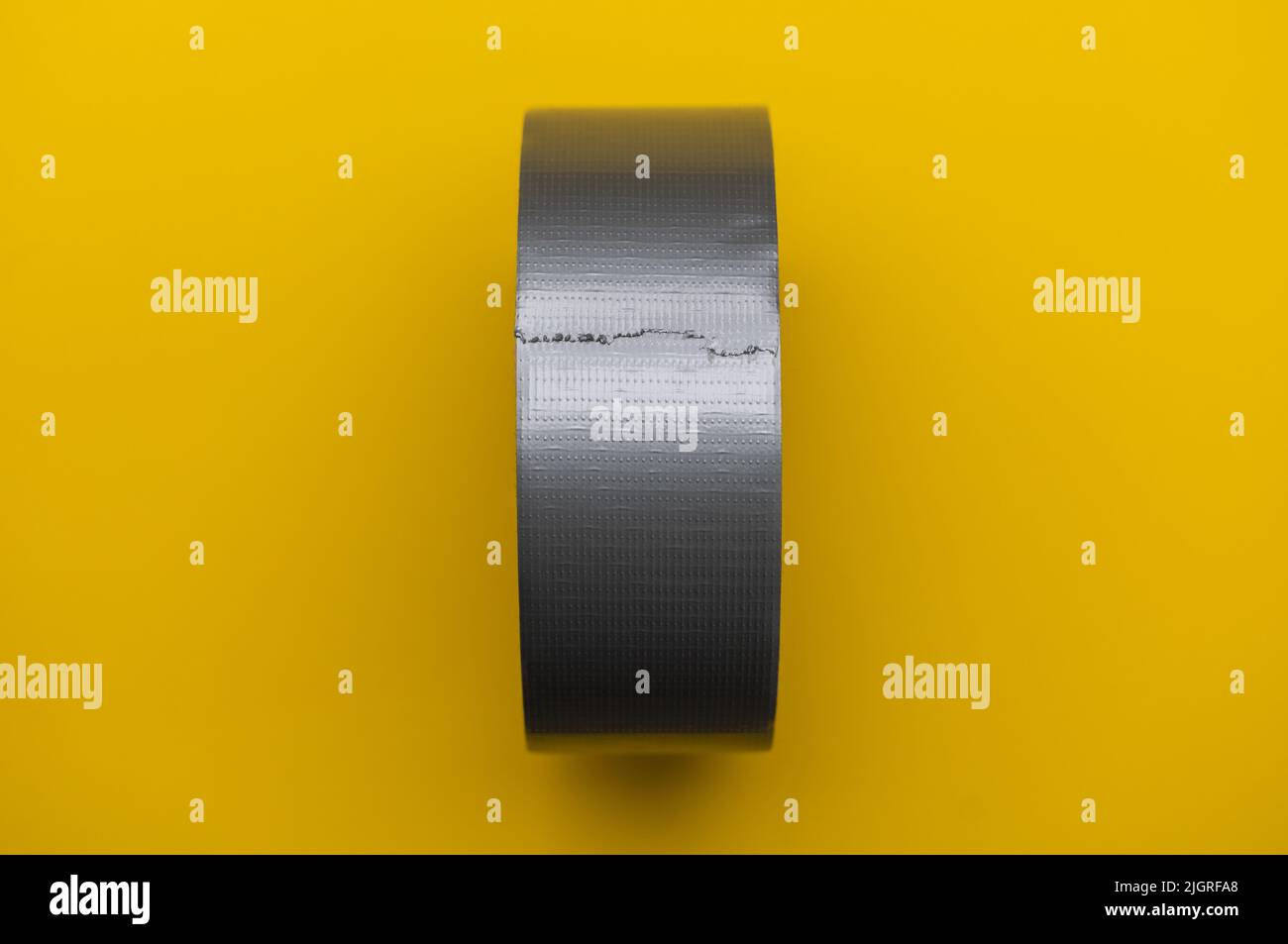 Duck tape on yellow background. Roll of tape closeup view. Duck tape ...
