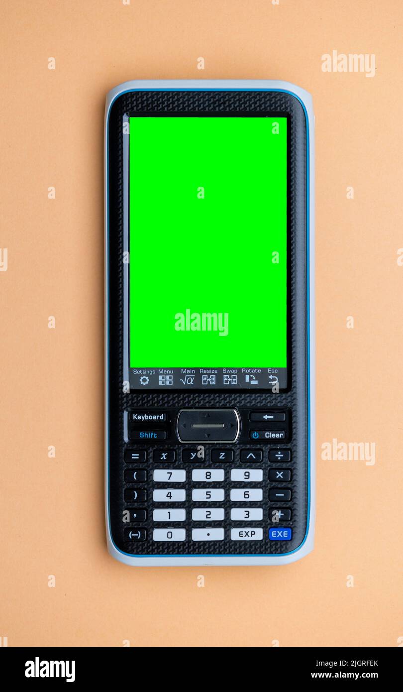Graphic calculator on orange background. Calculator with green screen ...