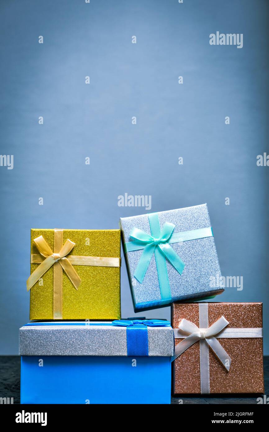 Multi colored gift boxes with bows different colors gray background ...