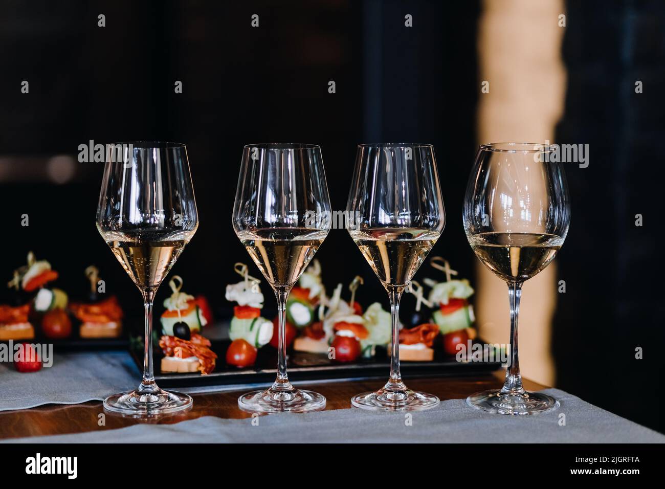 Champagne glasses on the background of snacks on the table. High ...