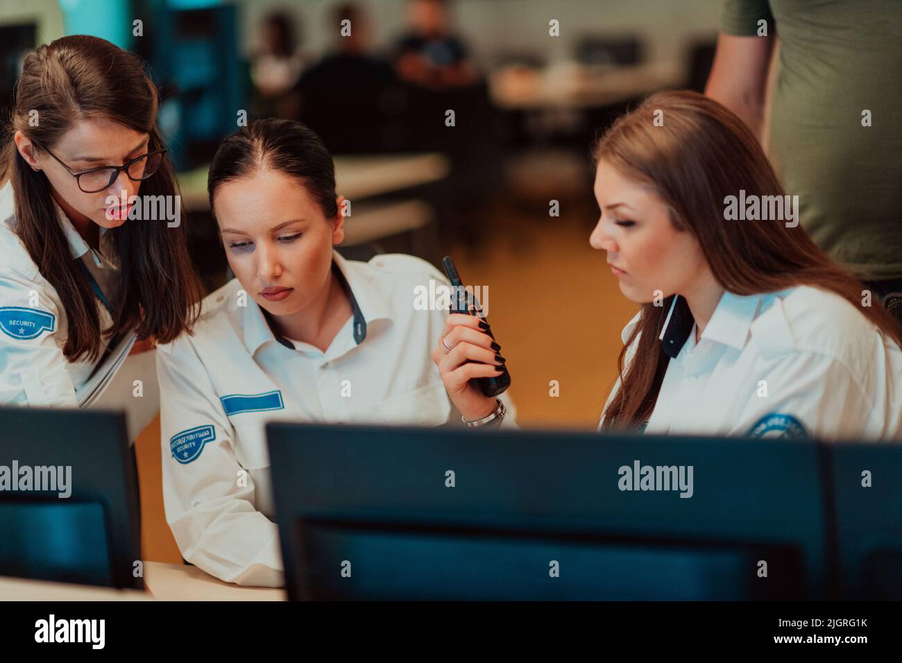 Group of female security operators working in a data system control ...