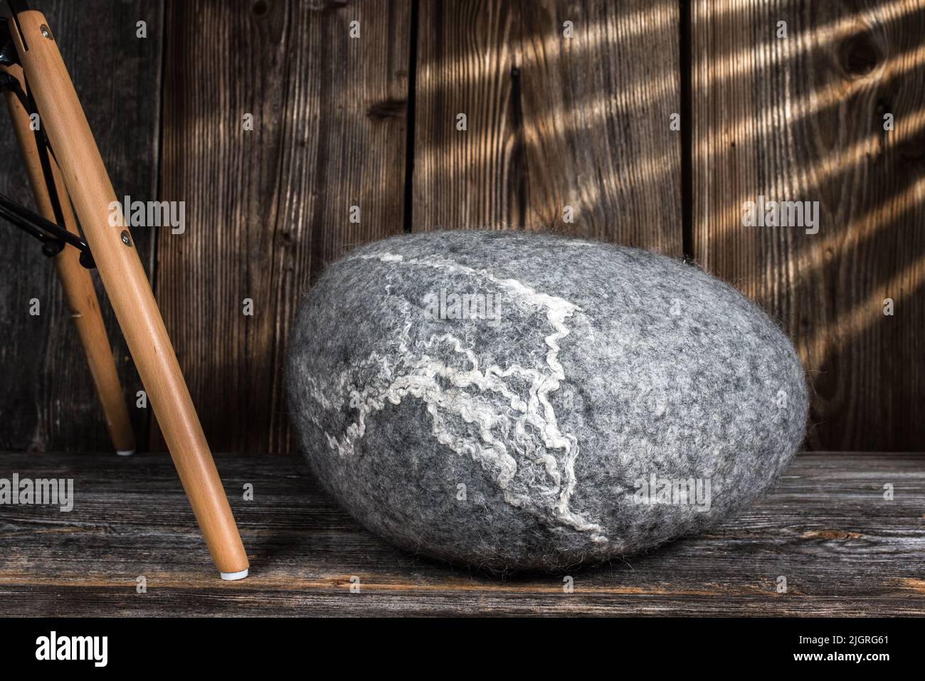 A closeup shot of a gray wool ball on wooden background Stock Photo - Alamy