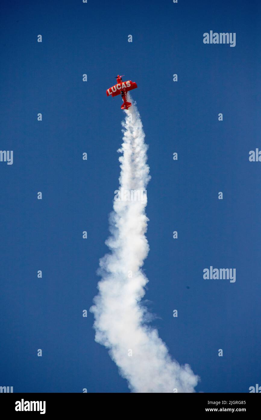 The Lucas Oil biplane trails ornamental smoke while performing ...