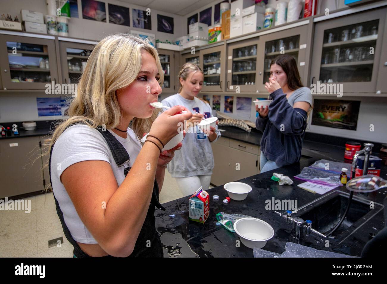 Happy high school girls taste do-it-yourself ice cream made in Ziploc ...