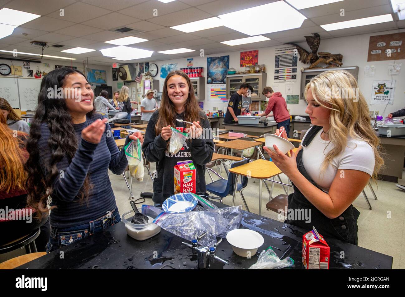 Happy high school girls taste do-it-yourself ice cream made in Ziploc ...