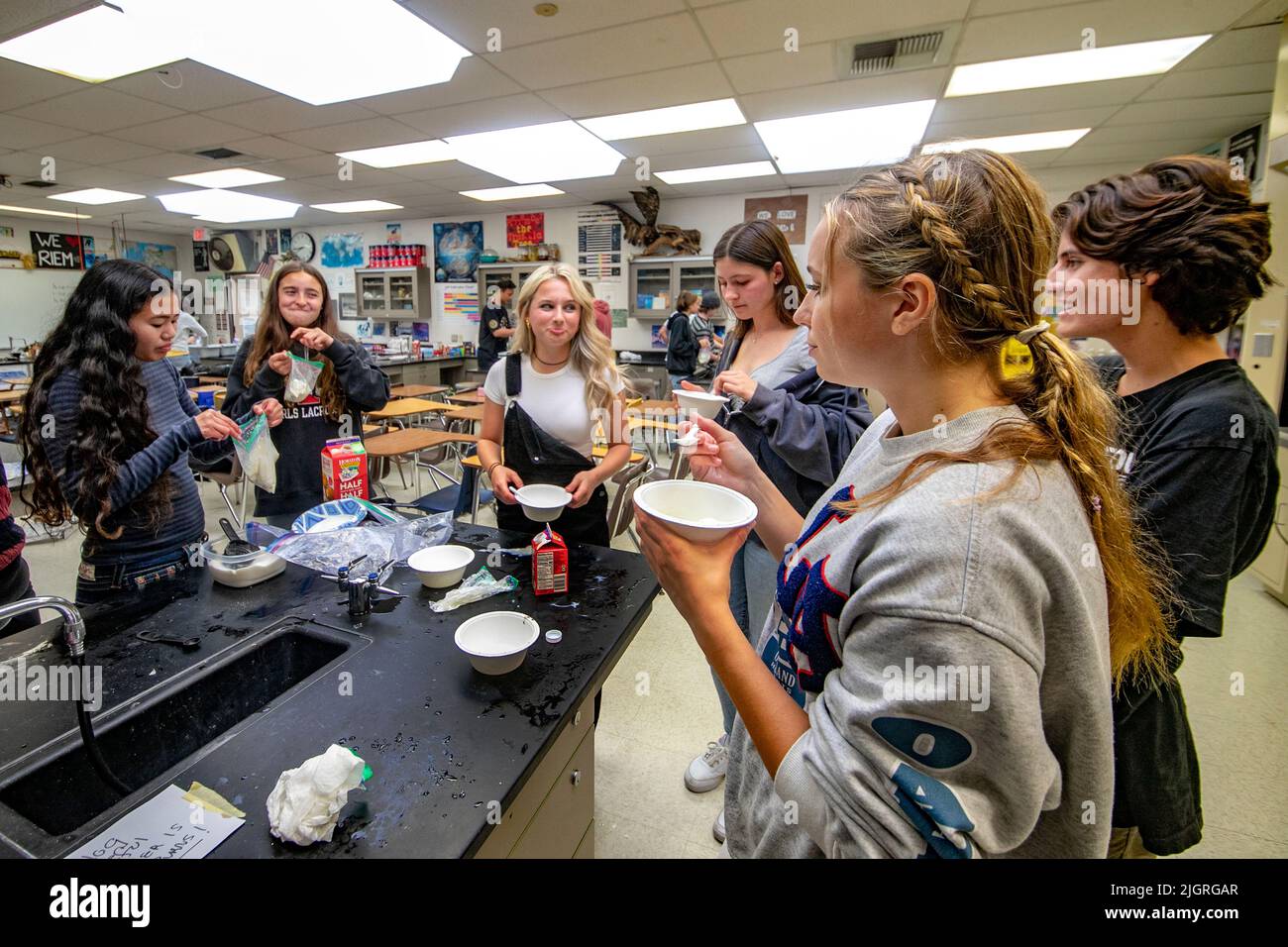 Happy high school girls taste do-it-yourself ice cream made in Ziploc ...