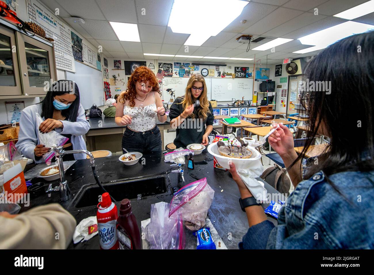 Happy high school girls taste do-it-yourself ice cream made in Ziploc ...