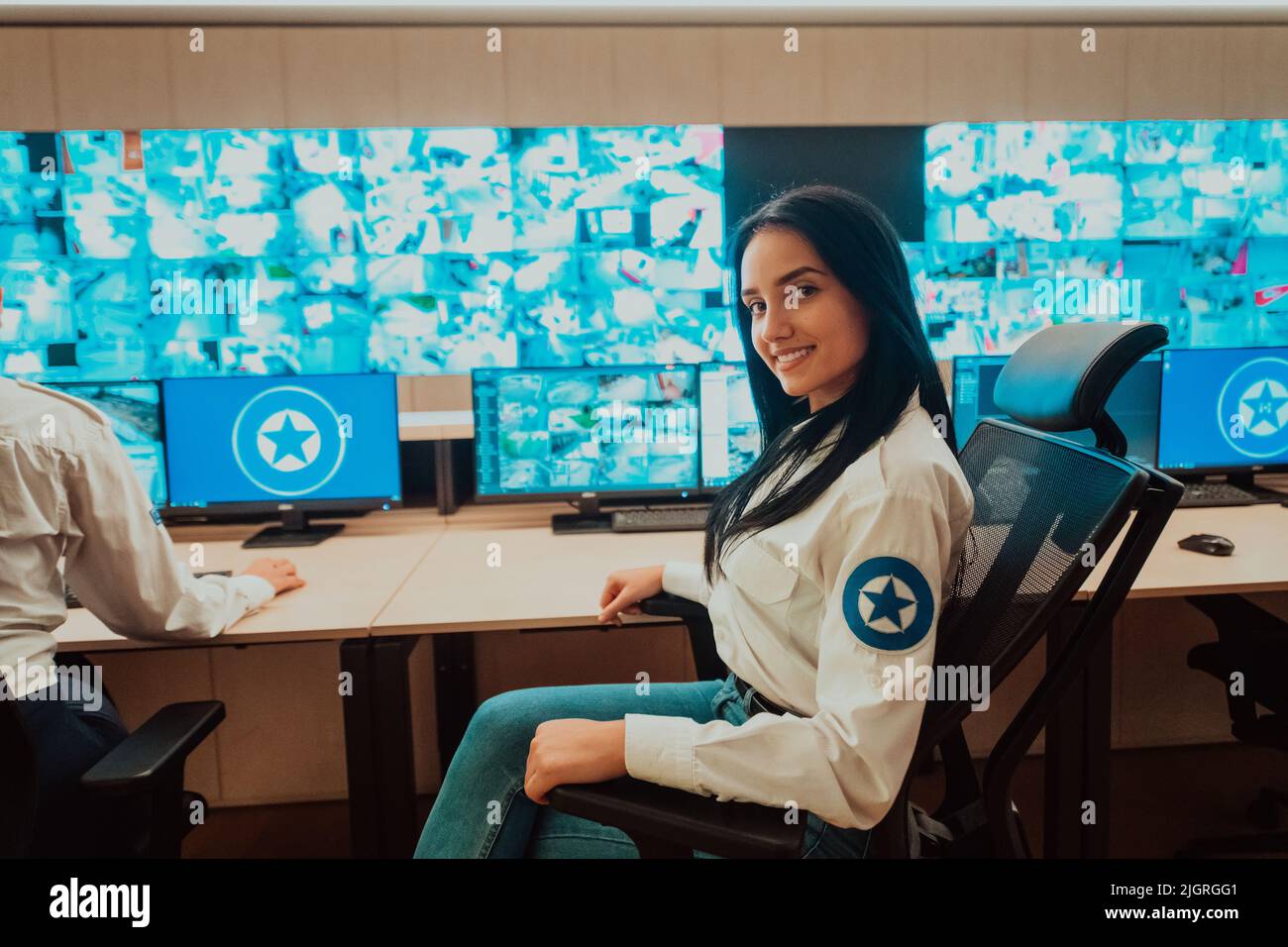 Female security operator working in a data system control room offices ...