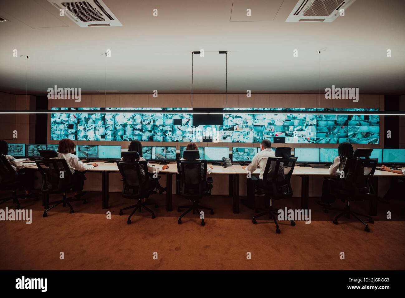 Group of Security data center operators working in a CCTV monitoring ...