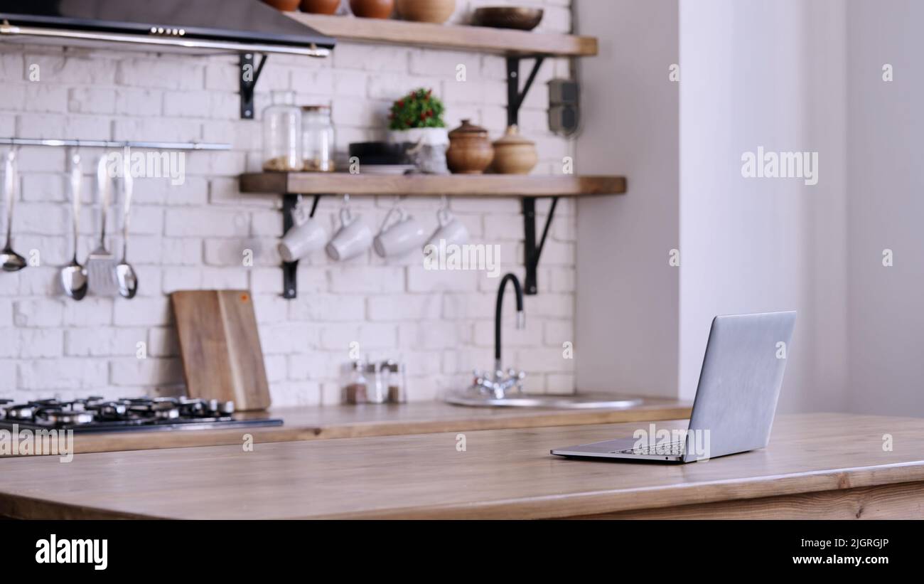 An interior design of laptop on kitchen desk with white brick wall and ...