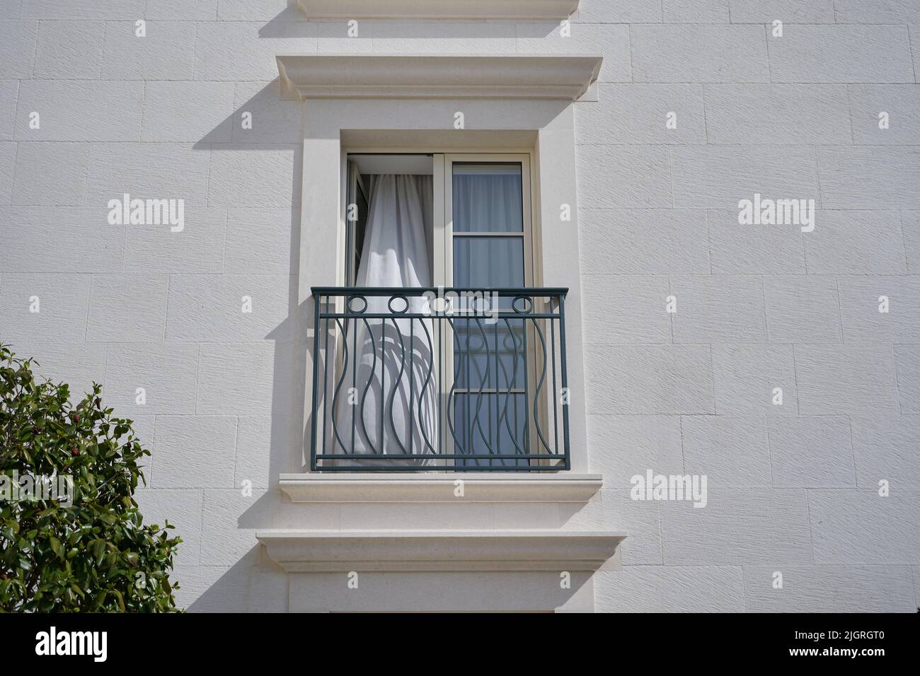 Open beige high window on Beige stone wall apartment building Stock ...