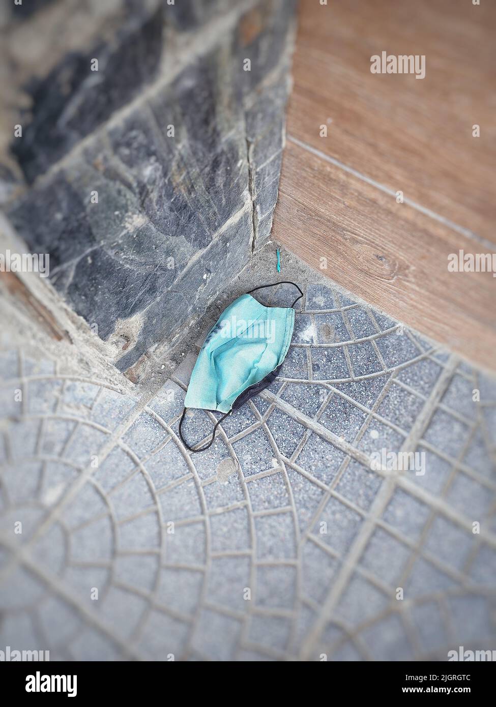 A vertical top view of a mask dropped on the ground Stock Photo - Alamy