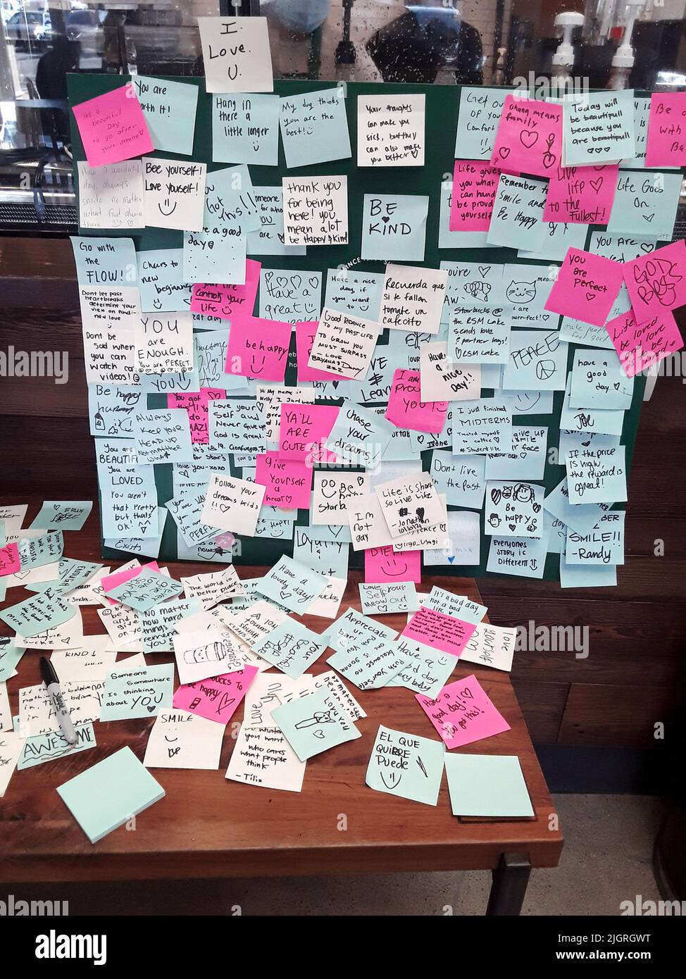 Colorful stickers on a message board take a positive and encouraging ...