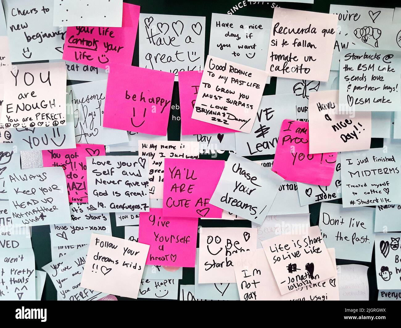 Colorful stickers on a message board take a positive and encouraging ...