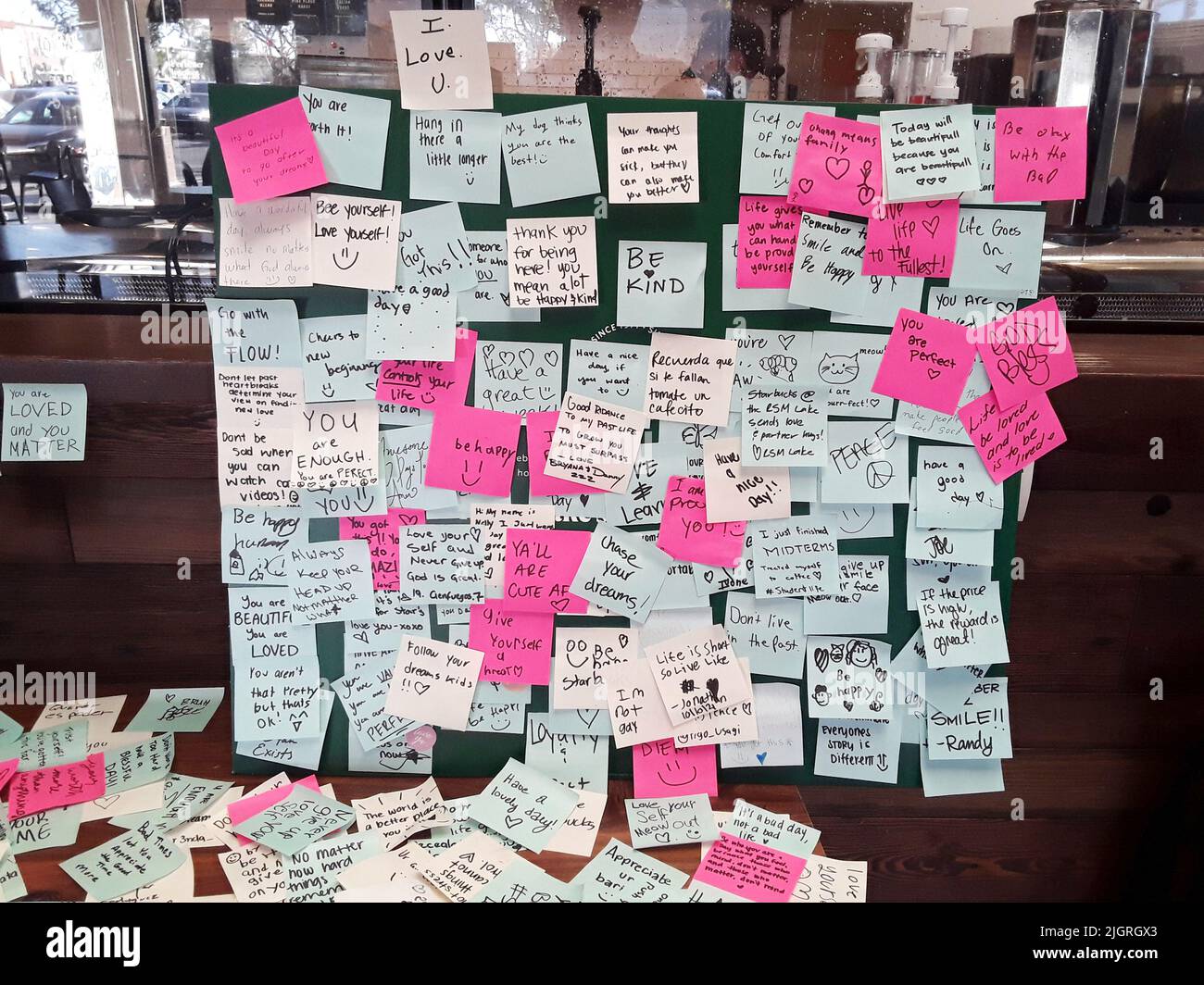 Colorful stickers on a message board take a positive and encouraging ...