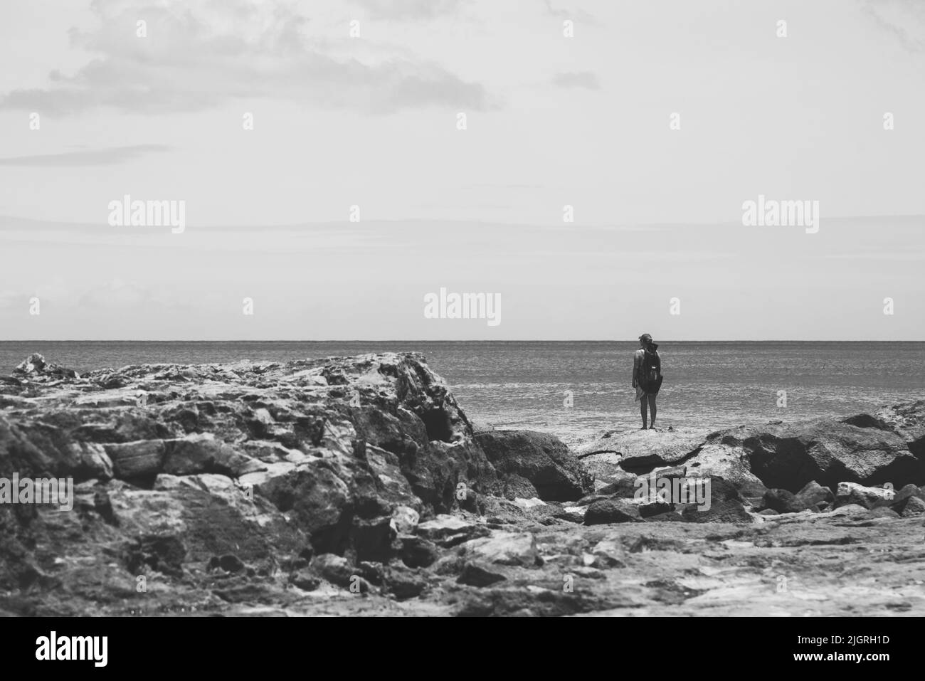 Person looking at ocean Stock Photo - Alamy
