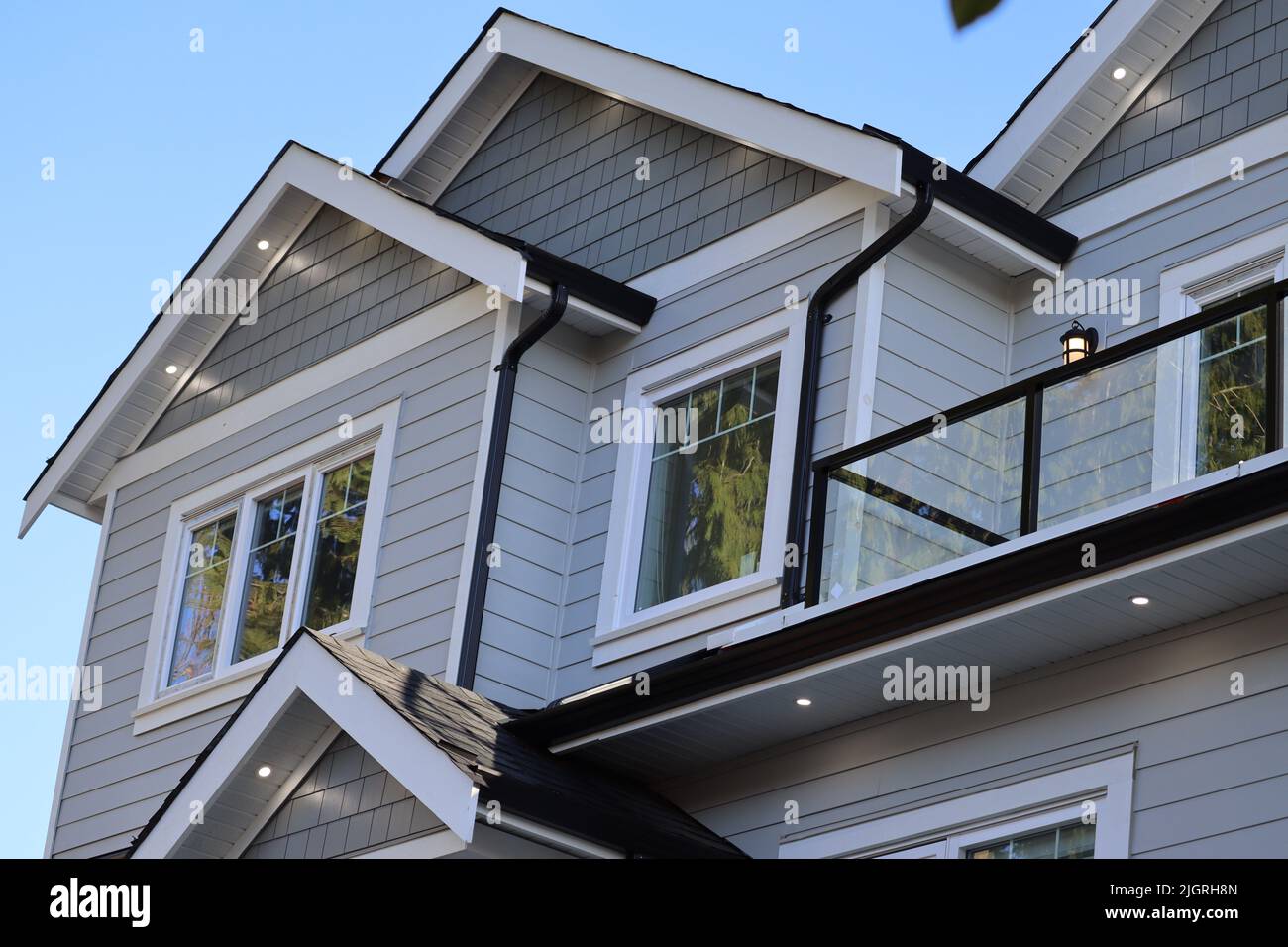 A low-angle view of modern houses in the background of sky Stock Photo ...