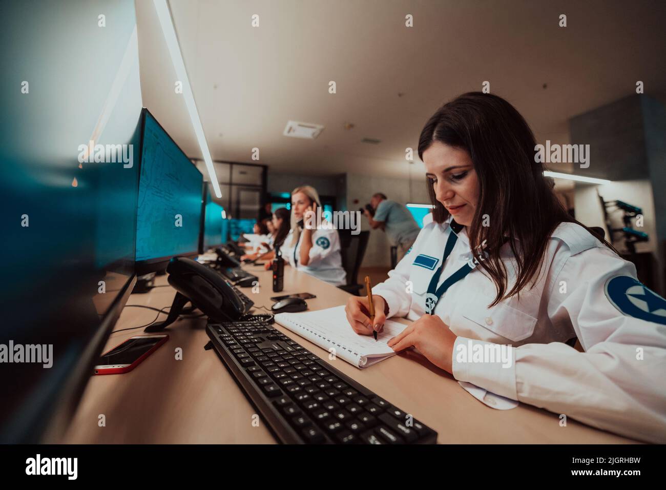 Group Of Female Security Operators Working In A Data System Control Room Technical Operators