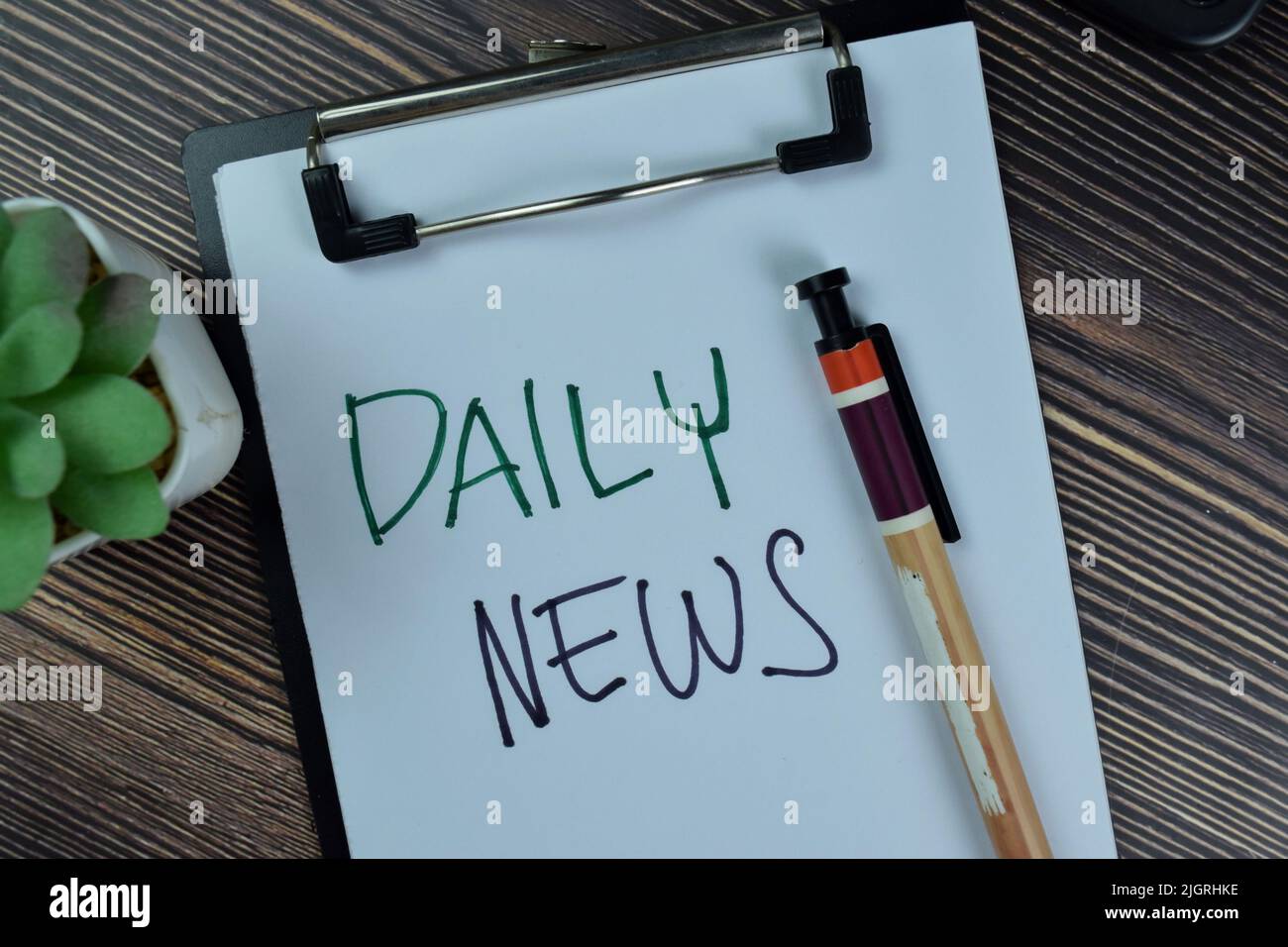 Concept of Daily News write on a paperwork isolated on Wooden Table ...
