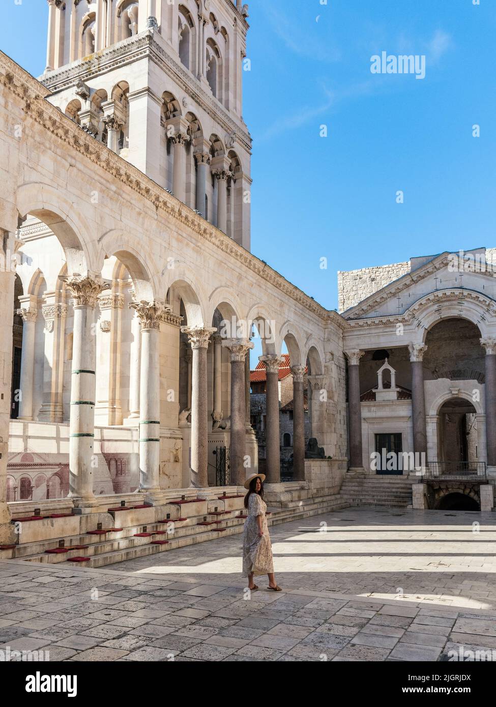 A Caucasian female standing on the peristyle of the Diocletian's Palace ...
