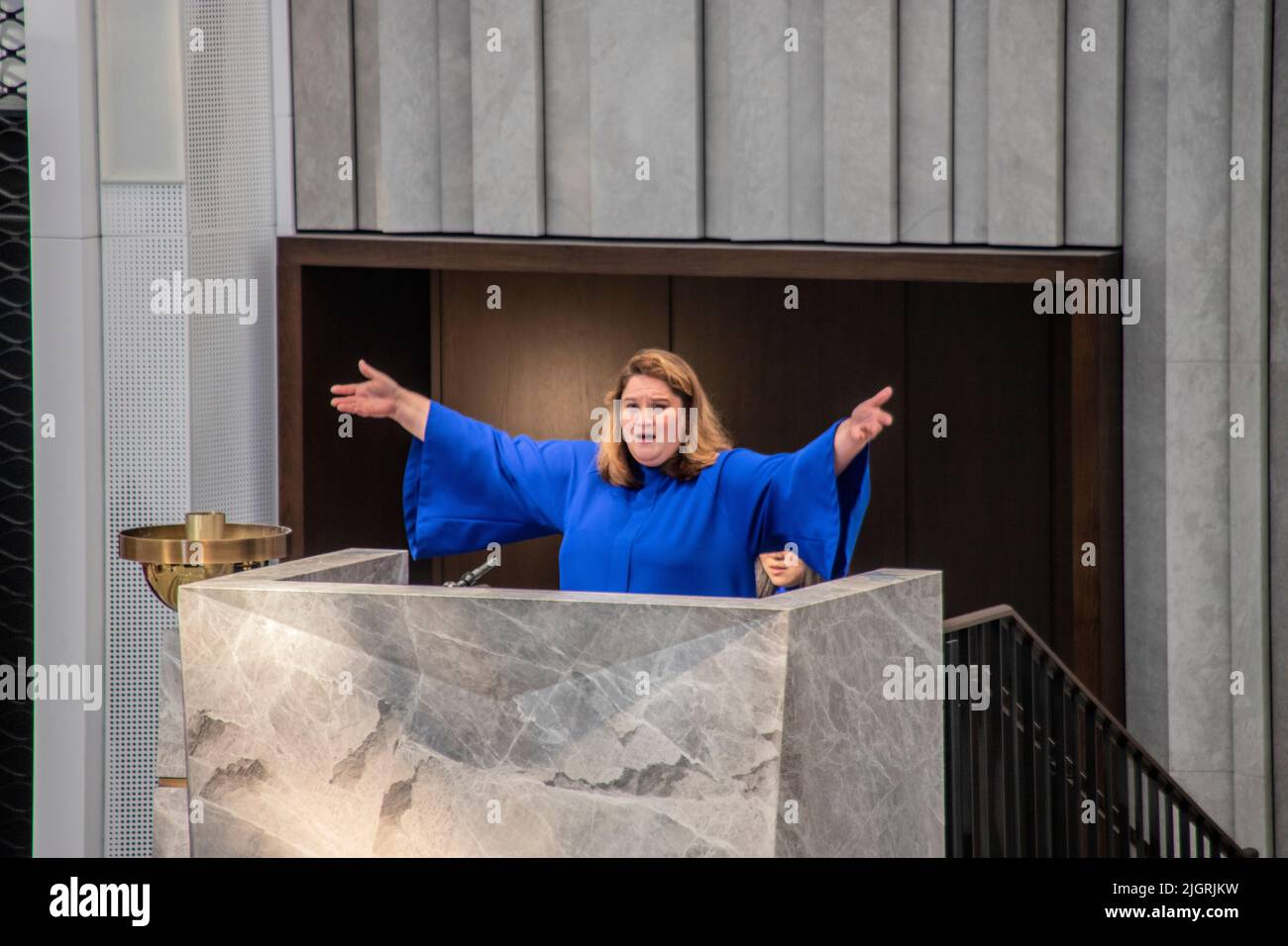 A blue robed lay female preacher helps conduct mass at a Garden Grove ...