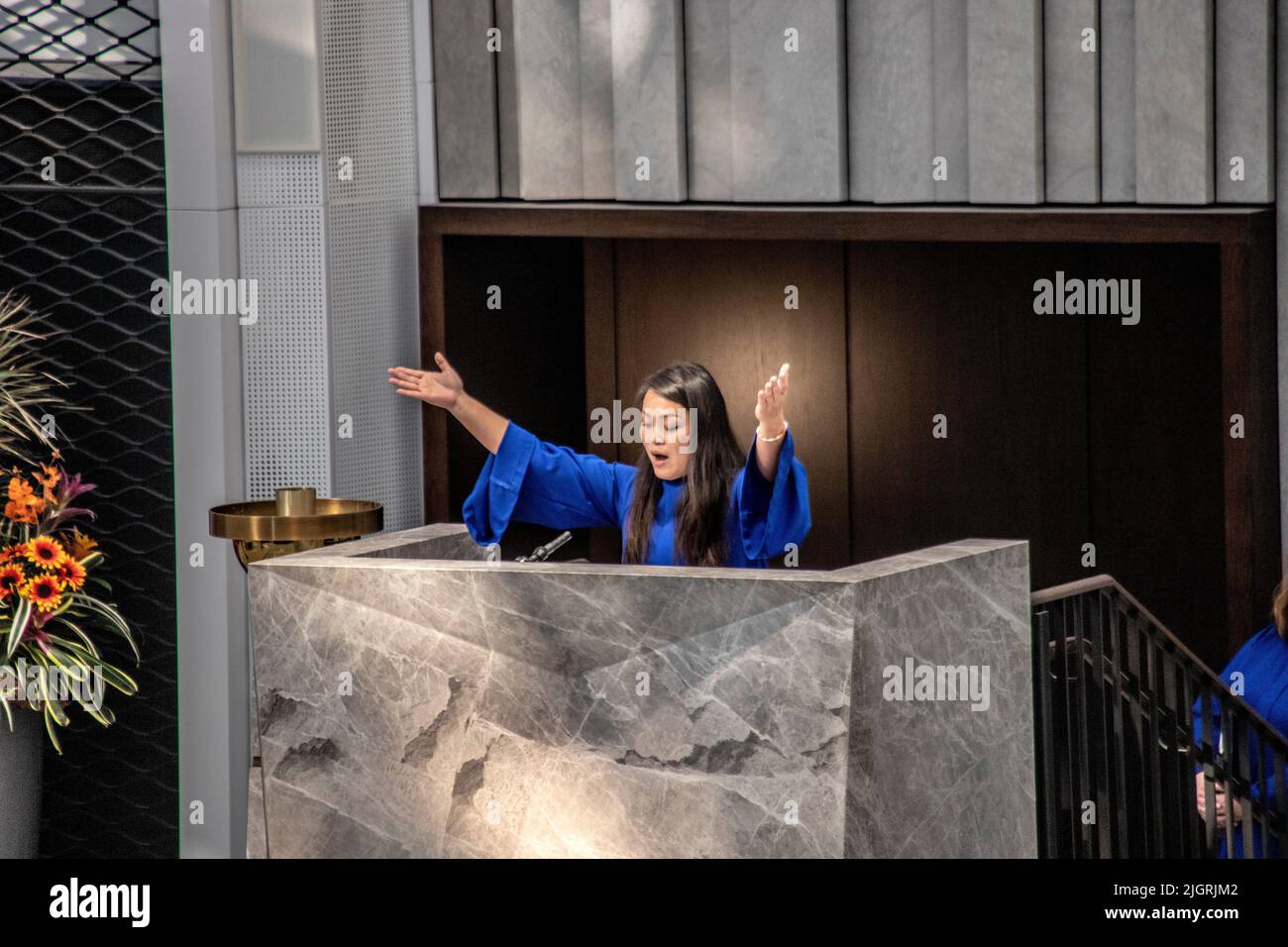 A blue robed lay female preacher helps conduct mass at a Garden Grove ...