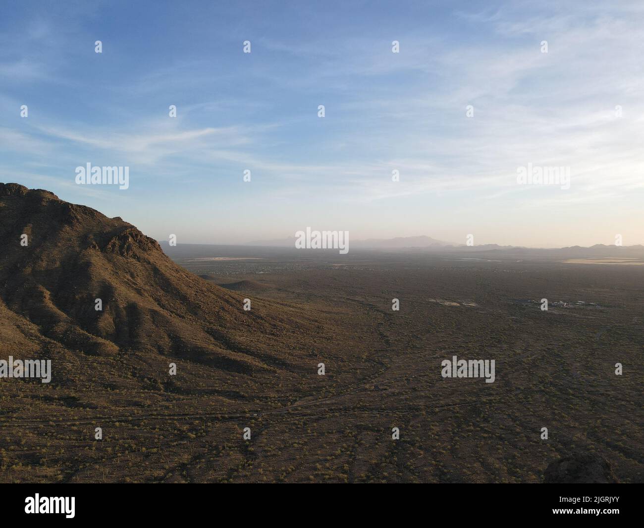 An aerial view of a landscape with rocky mountain top and vast open ...