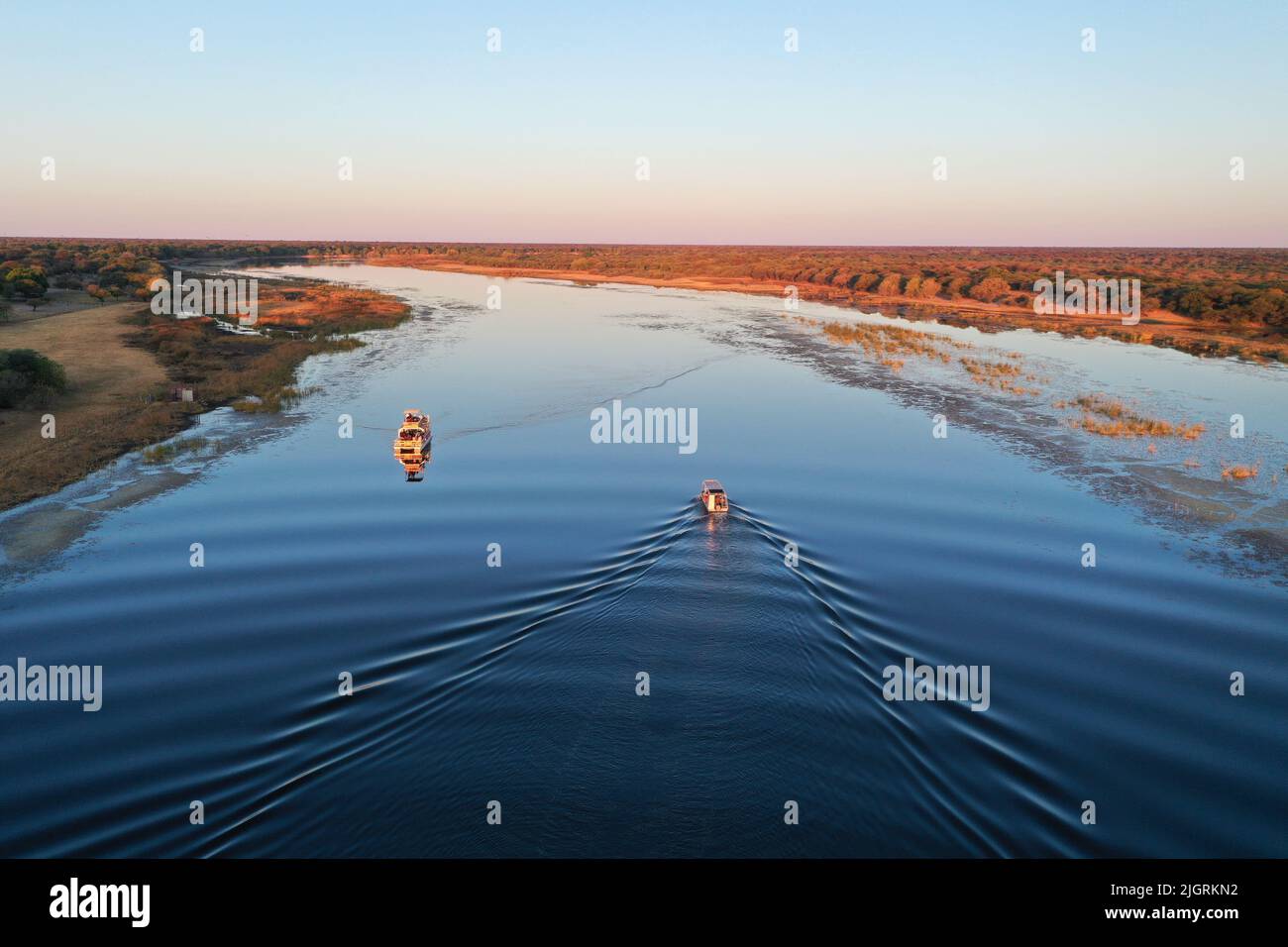 An aerial view of the Boteti river with boats in Chanoga, Botswana ...