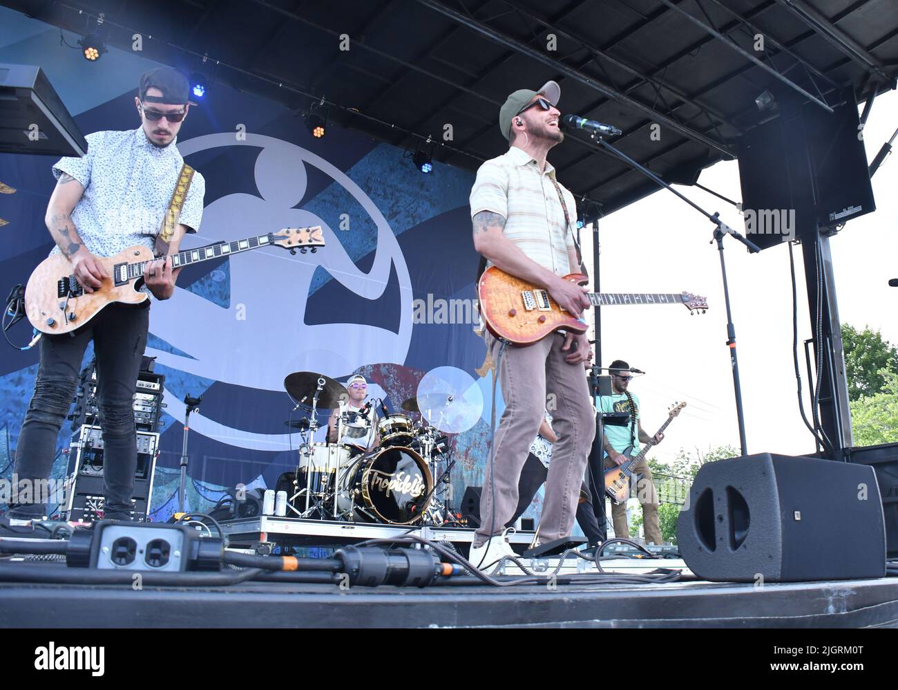 Tropidelic band members are shown performing on stage during a “live ...