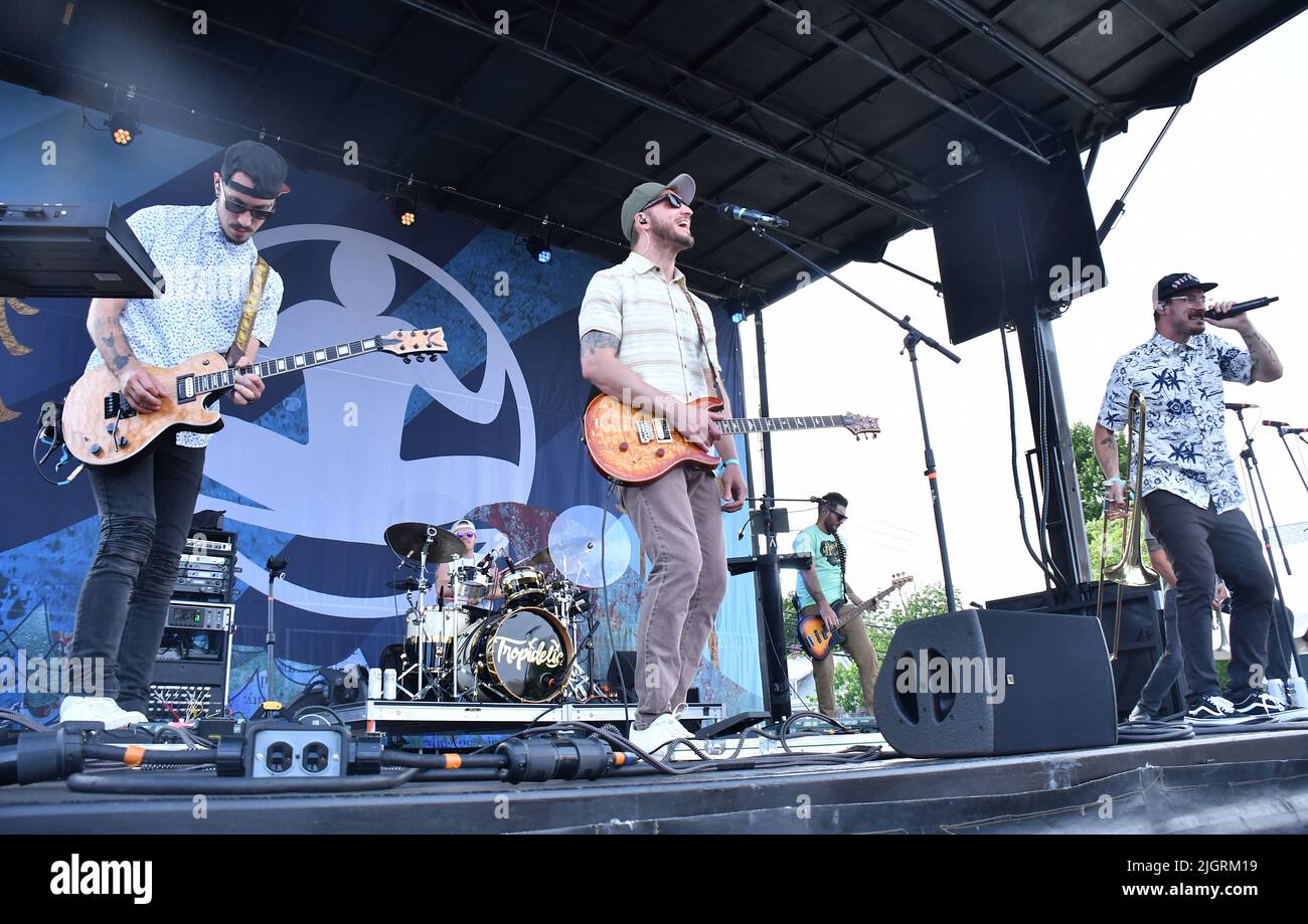 Tropidelic band members are shown performing on stage during a “live ...
