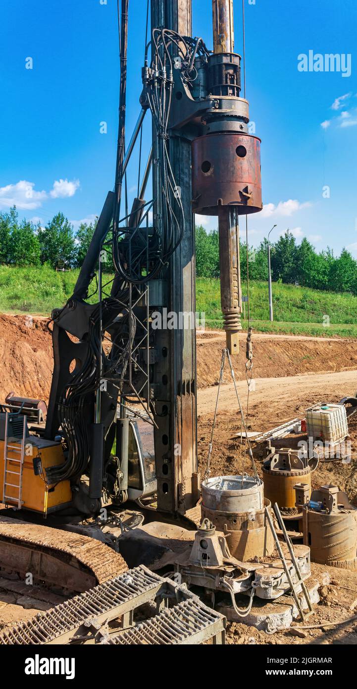 machine for drilling deep piles is preparing to work on the ...
