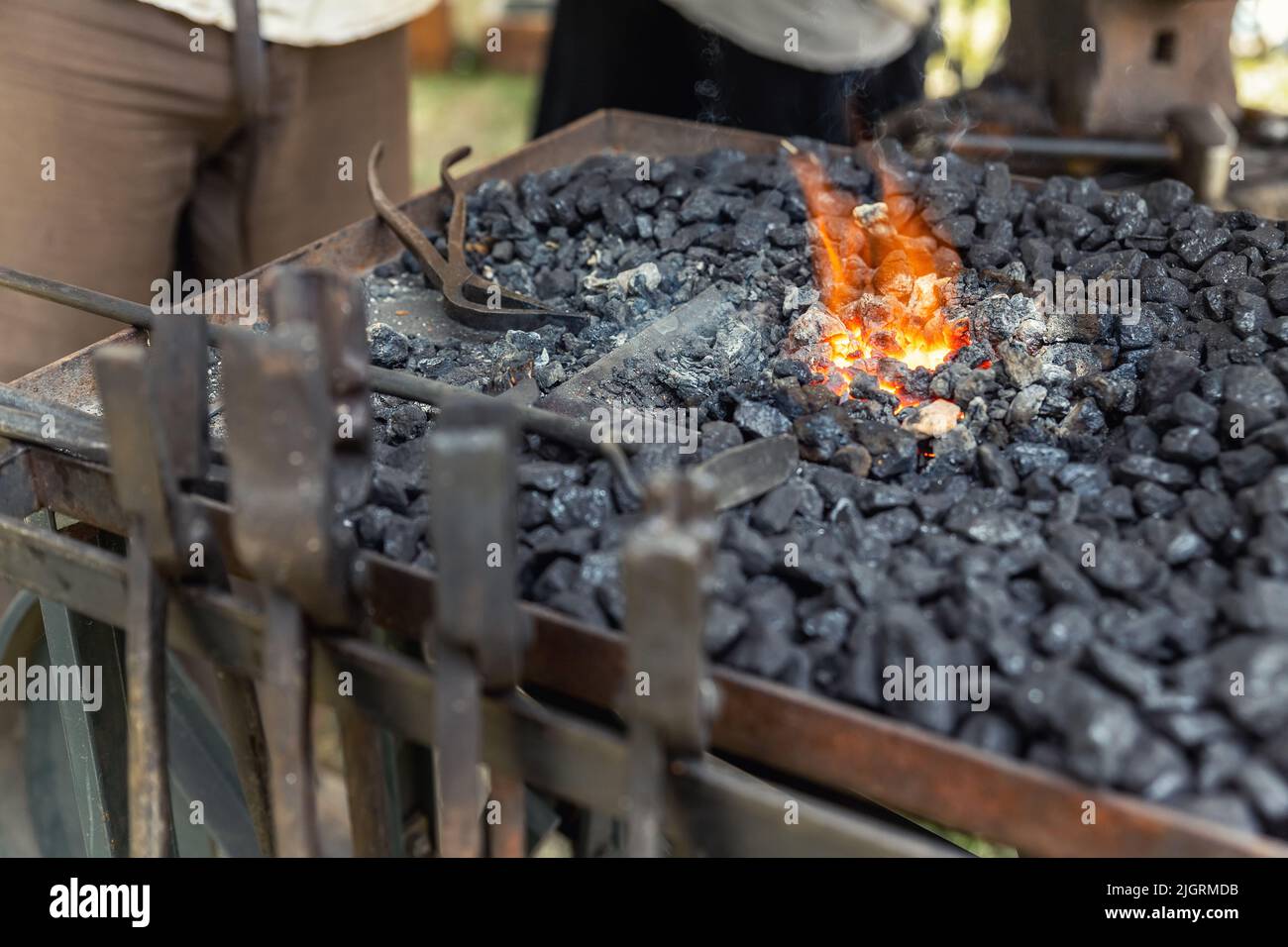 Close-up detail old medieval blacksmith furnace with hot burning coal ...
