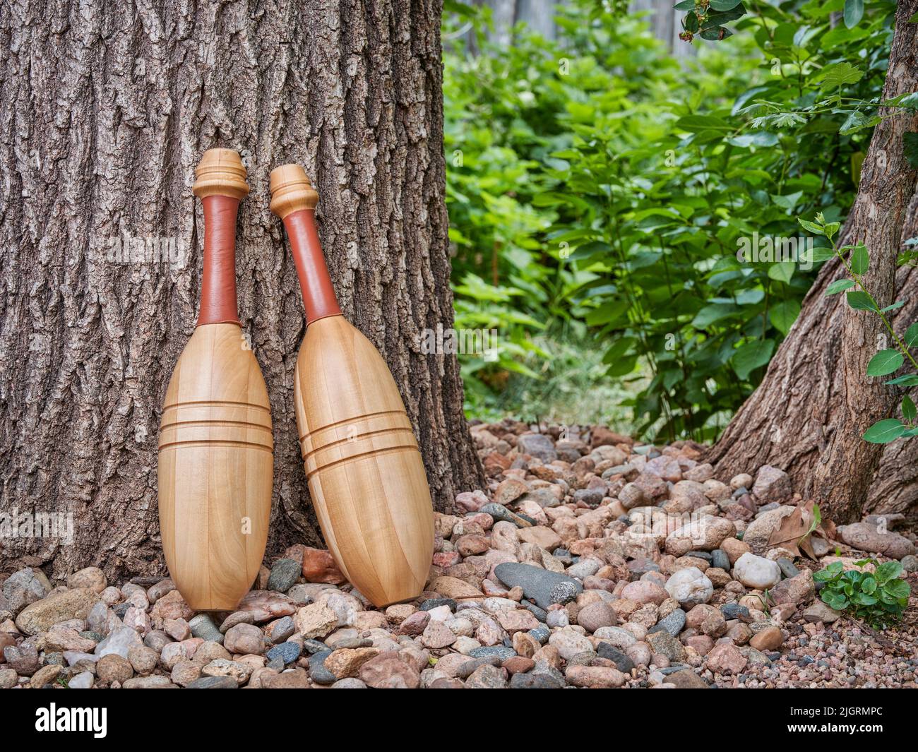 pair of Indian exercise clubs in backyard or park - functional fitness ...