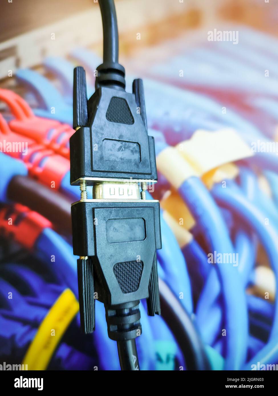 Both end of a VGA Cable (Male and Female) connected In front of a ...