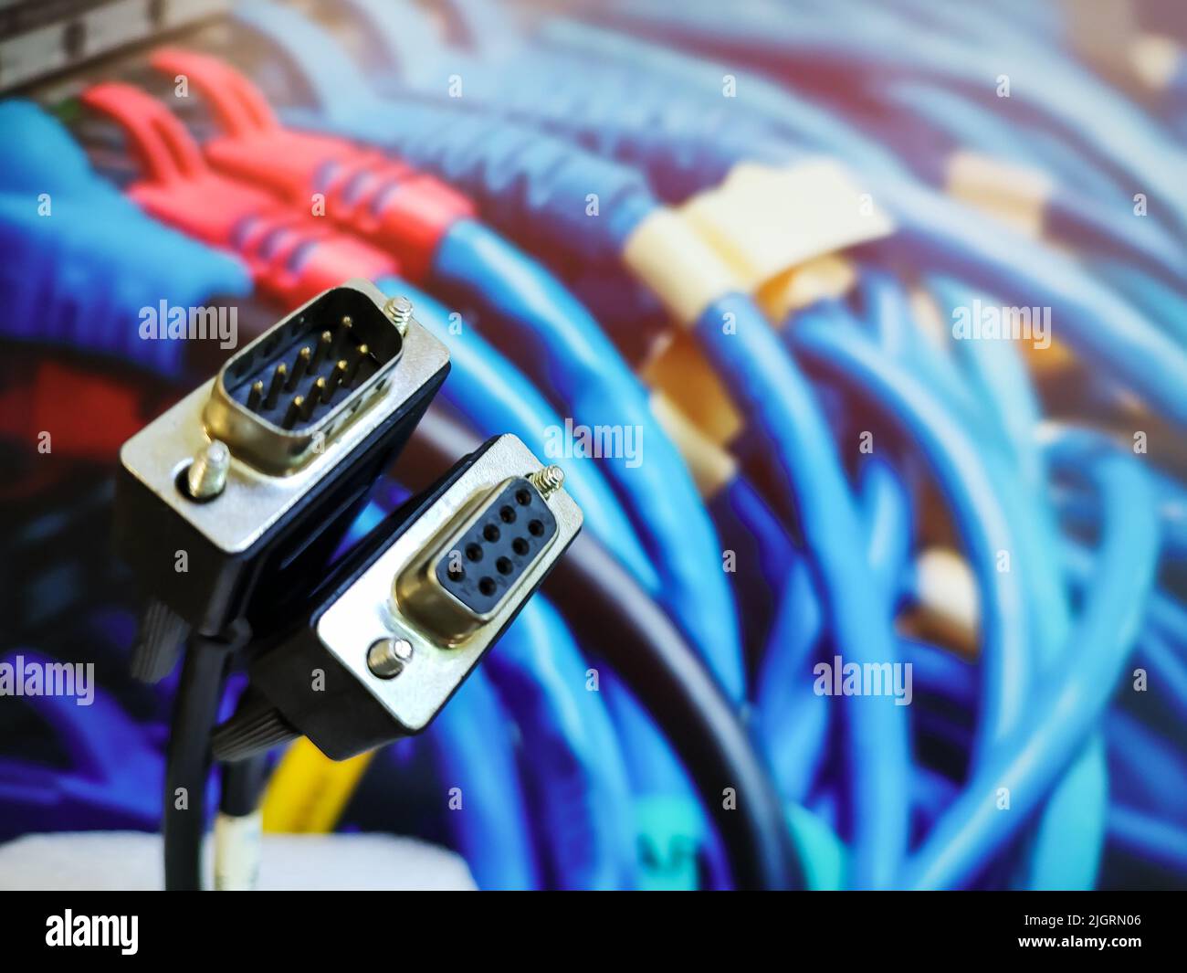 Both end of a VGA Cable (Male and Female) having nine pins In front of ...