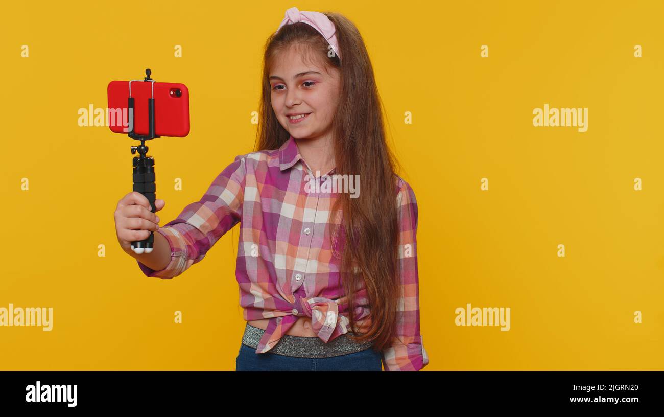 Young preteen child girl kid blogger taking selfie on smartphone selfie ...