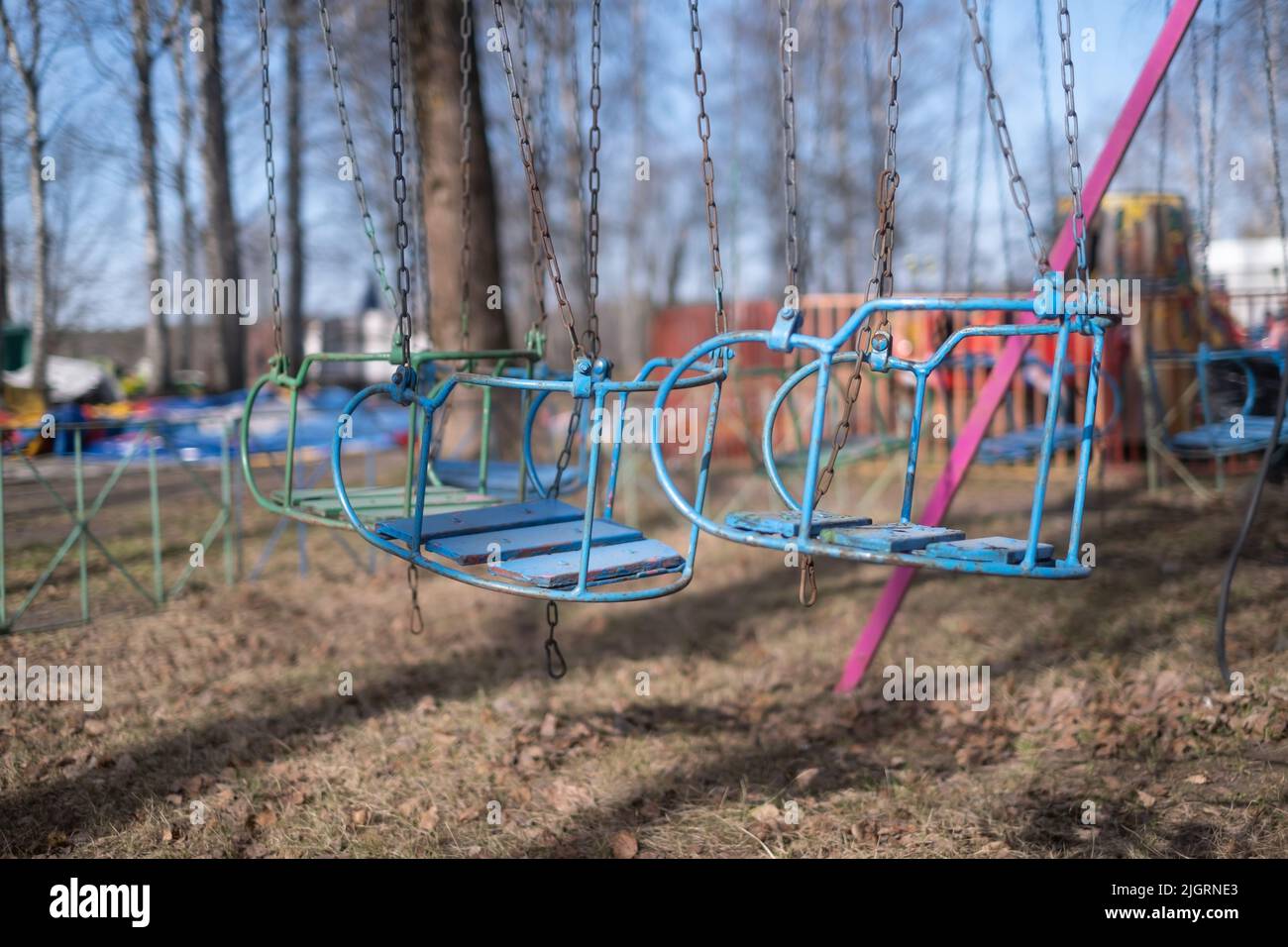Rusty carousel, rusty swing on old playground Stock Photo - Alamy