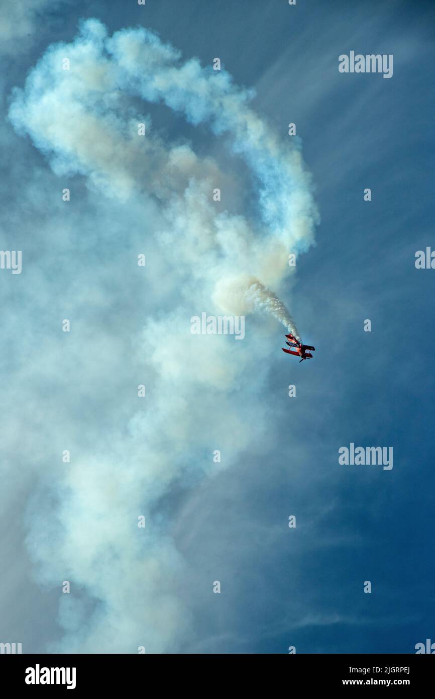 The Lucas Oil biplane trails ornamental smoke while performing ...